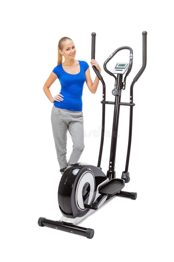 Young Woman Uses Elliptical Cross Trainer. Stock Image - Image of ...
