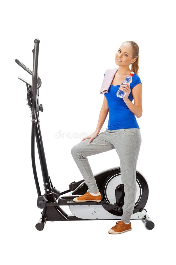 Young Woman Uses Elliptical Cross Trainer. Stock Image - Image of ...