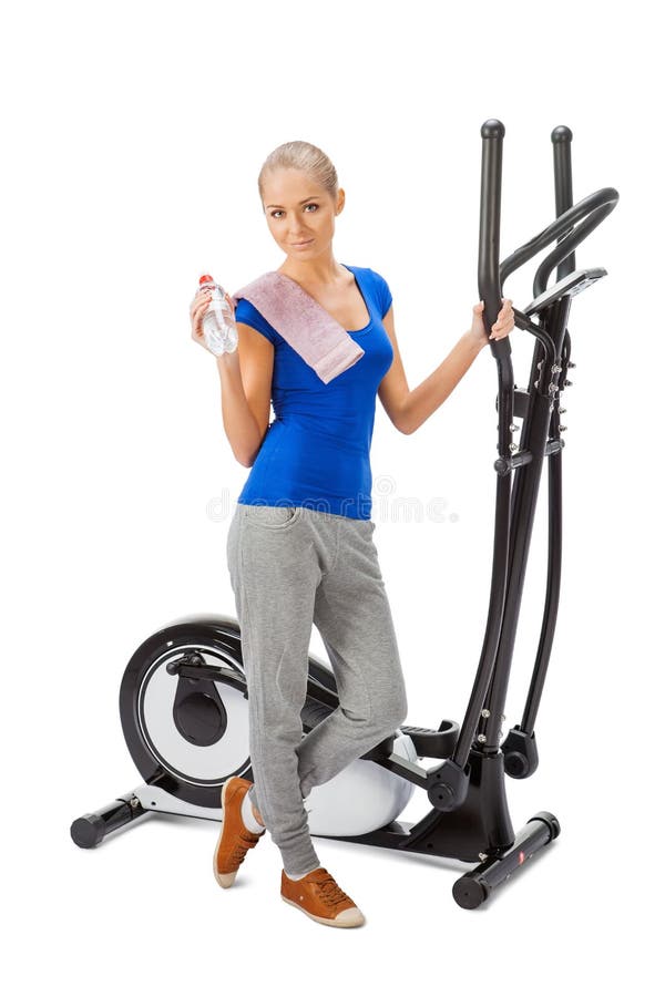 Young Woman Uses Elliptical Cross Trainer. Stock Photo - Image of ...