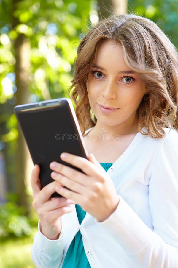 Young Woman Uses Tablet Pc. Stock Photo - Image of park, female: 41725294