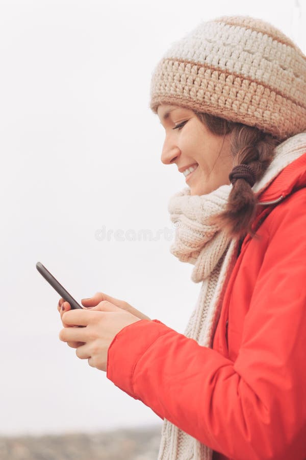 Young Woman Using Cell Mobile Phone Typing and Smiling Stock Photo ...