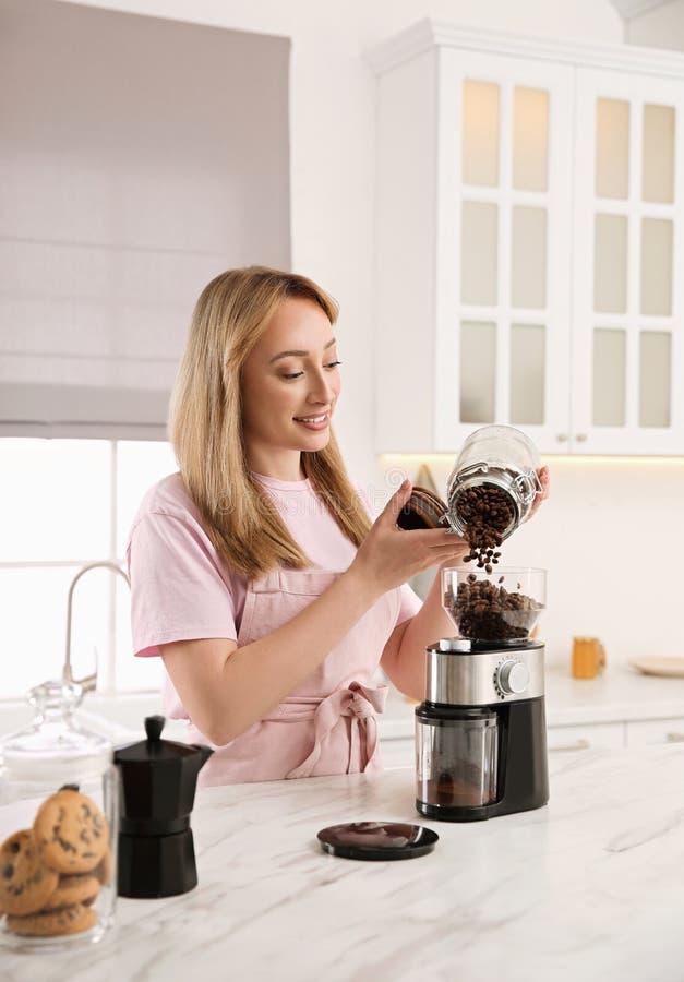 Young Woman Using Coffee Grinder in Kitchen Stock Image - Image of ...