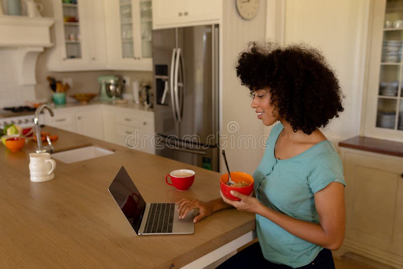 Young Woman Using Computer in the Kitchen Stock Image - Image of ...