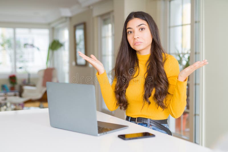 Young Woman Using Computer Laptop Clueless and Confused Expression with ...
