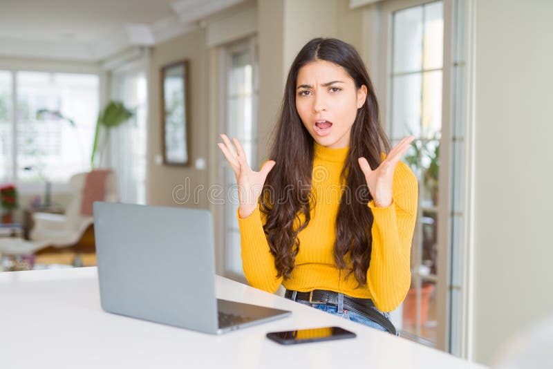 Young Woman Using Computer Laptop Crazy and Mad Shouting and Yelling ...