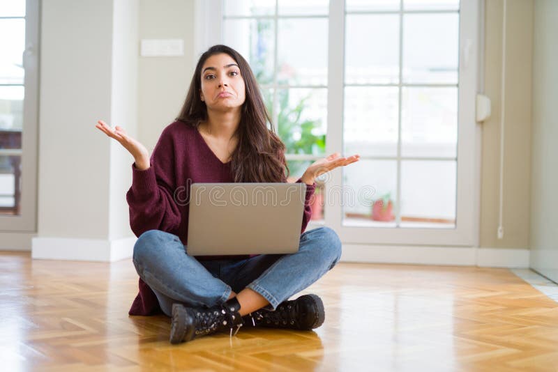 Young Woman Using Computer Laptop Sitting on the Floor Clueless and ...