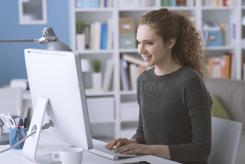 Young Woman Using a Computer in the Office Stock Photo - Image of ...