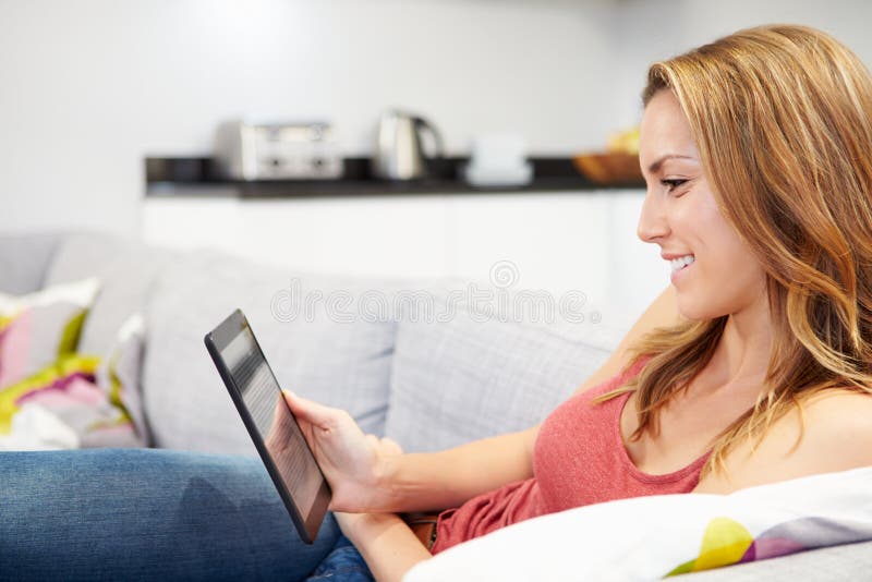 Young Woman Using Digital Tablet at Home Stock Image - Image of ...