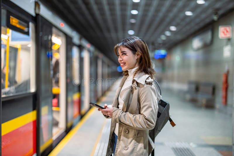 Smiling Young Woman Using Mobile Phone in a Public Transport Stock ...