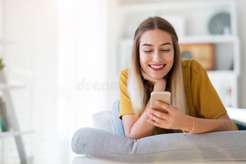 Young Woman Using Her Smartphone at Home Stock Photo - Image of ...