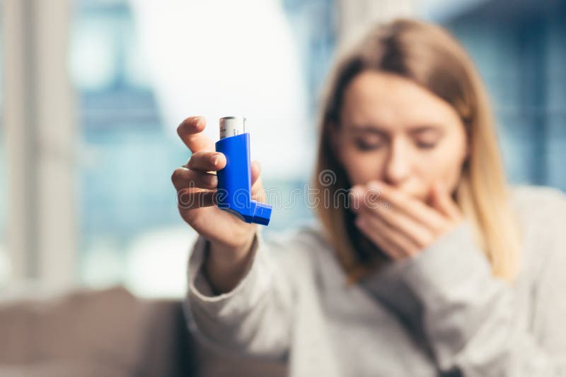 Young Woman Using Inhaler while Suffering from Asthma at Home Stock ...