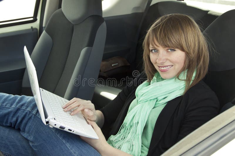 Young Woman Using Laptop in the Car Stock Photo - Image of pleasant ...