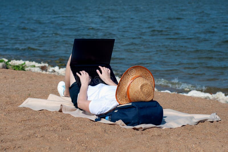 Young Woman Using Laptop Computer on a Beach. Freelance Work Concept ...