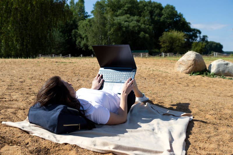 Young Woman Using Laptop Computer on a Beach. Freelance Work Concept ...