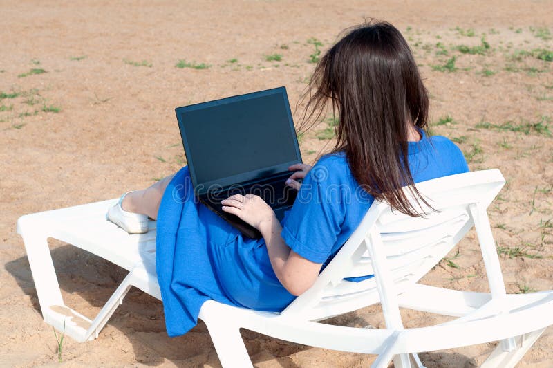 Young Woman Using Laptop Computer on a Beach. Freelance Work Concept ...
