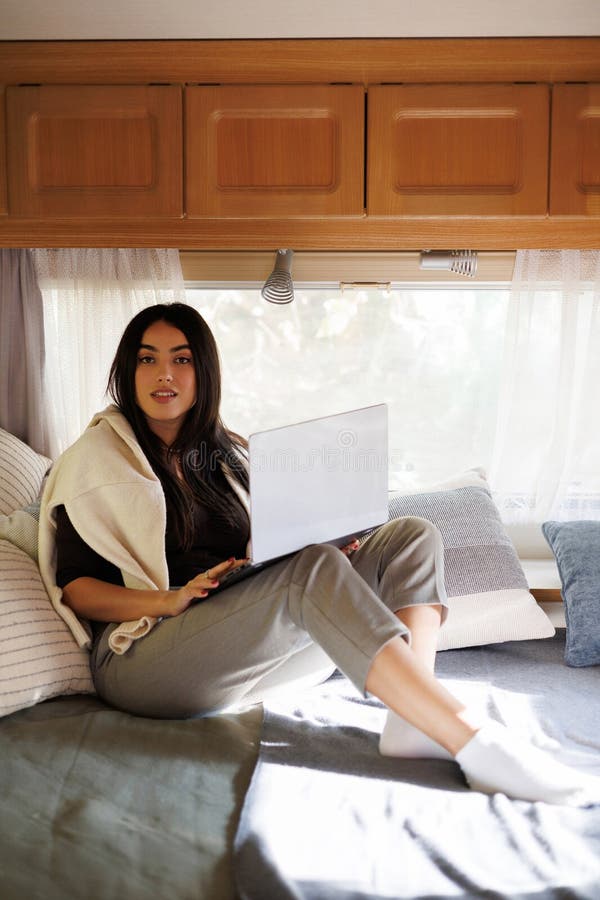 Young Woman Using Laptop Computer on Bed of a Camper RV Van Stock Photo ...