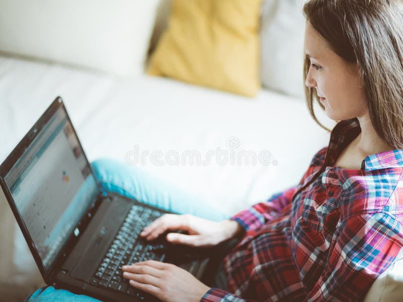 Young Woman Using Laptop Computer at Home. Working from Home. Stock ...