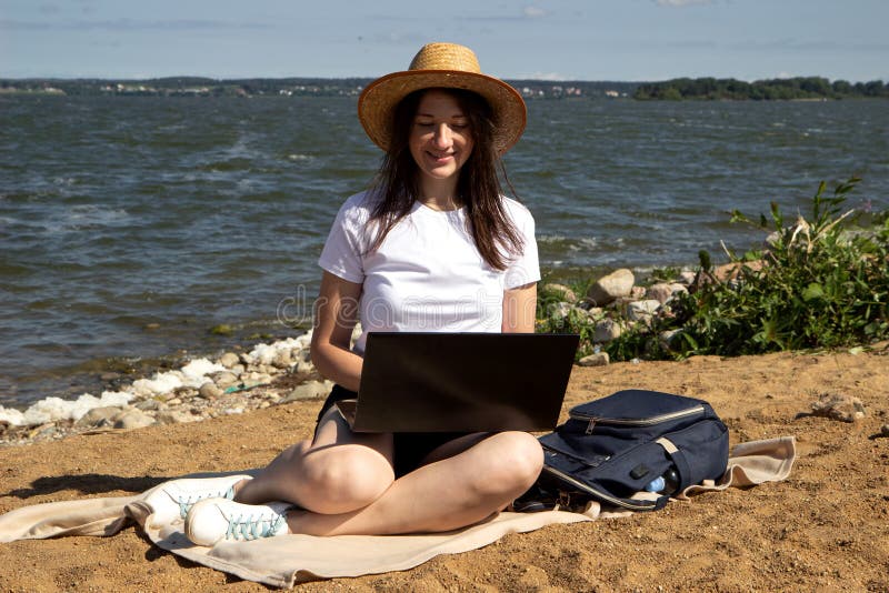 Young Woman Using Laptop Computer on Sunbed on a Beach. Freelance Work ...