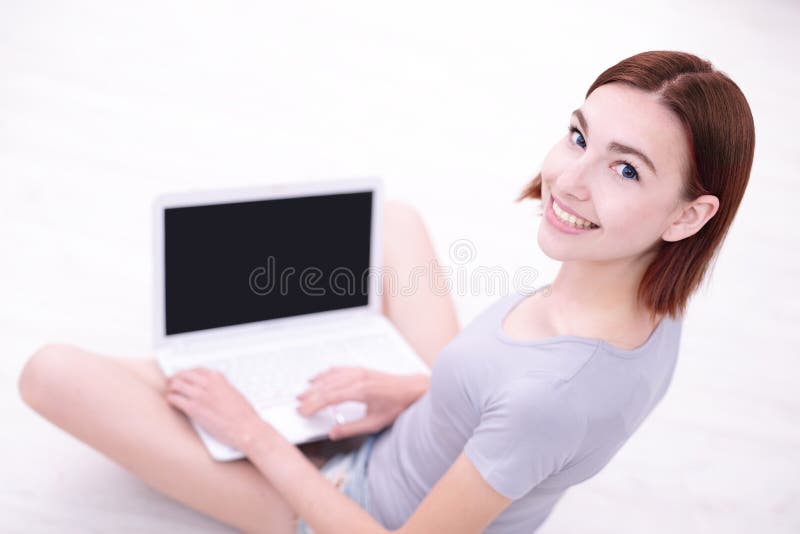 Young woman using laptop stock photo. Image of floor - 66837674