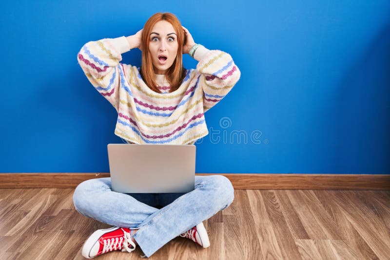 Young Woman Using Laptop at Home Sitting on the Floor Crazy and Scared ...