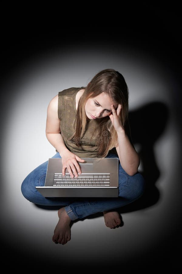 Young Woman Using Laptop in Pool of Light Stock Image - Image of ...