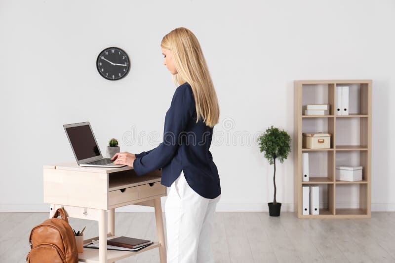 Young Woman Using Laptop at Stand Stock Image - Image of flat, high ...