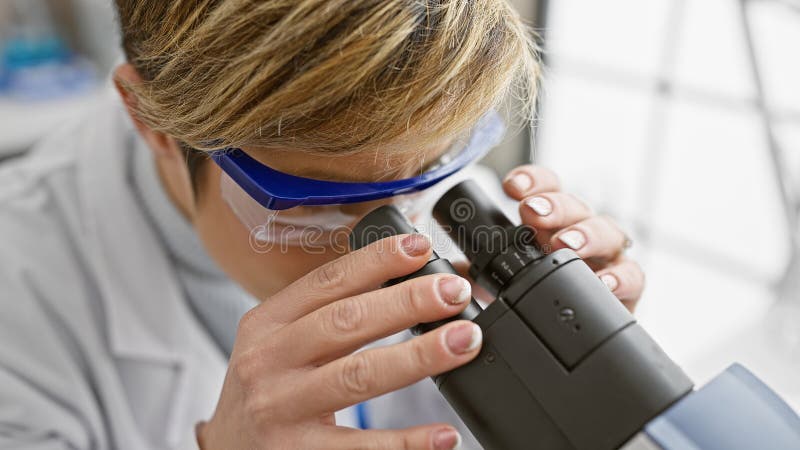 A Young Woman Using a Microscope in a Laboratory Setting, Signifying ...