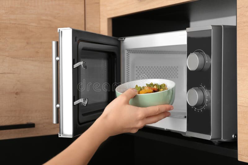 Young Woman Using Microwave Oven Stock Photo - Image of device, cooking ...