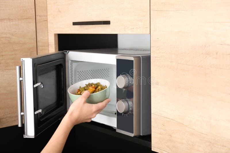 Young Woman Using Microwave Oven Stock Image - Image of food ...