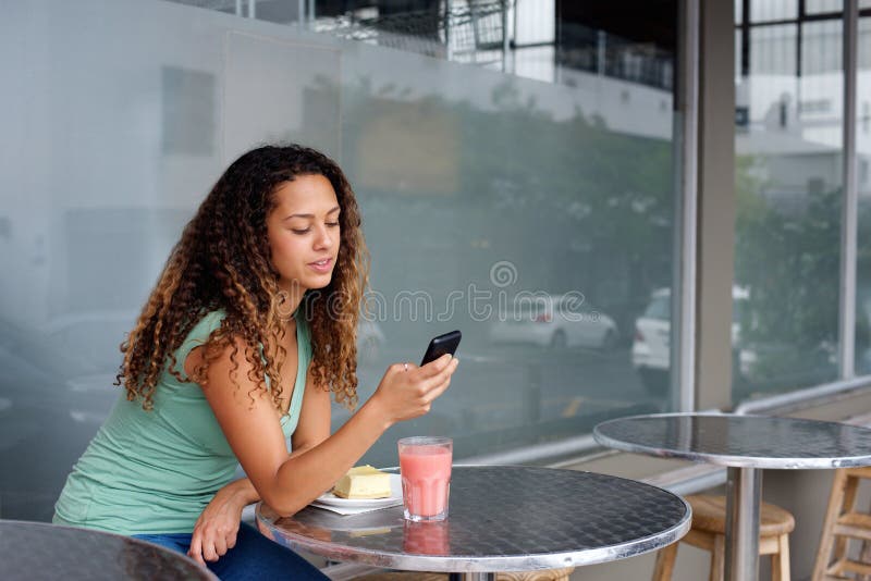 Young Woman Using Mobile Phone at Outdoor Cafe Restaurant. Stock Photo ...