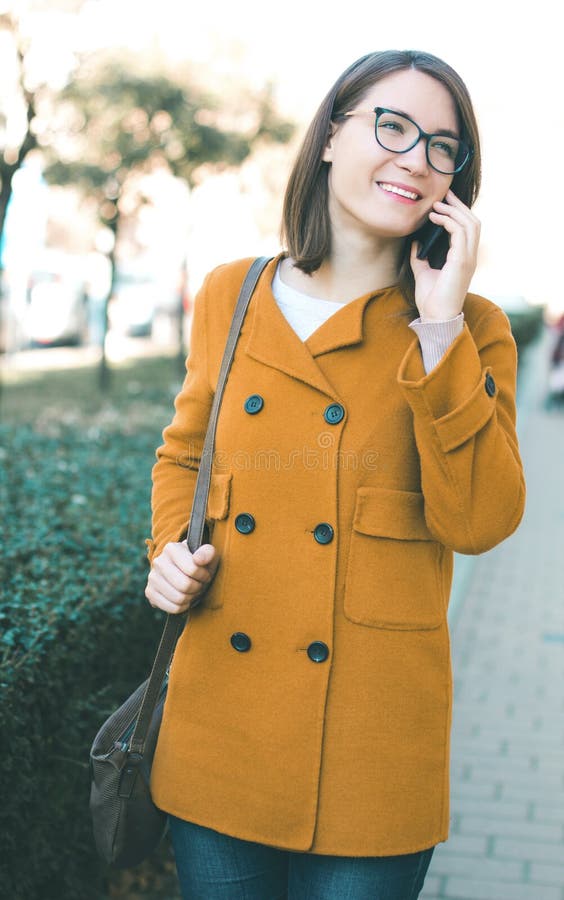 Young Woman Using Mobile Phone Outdoors Calling Stock Image - Image of ...
