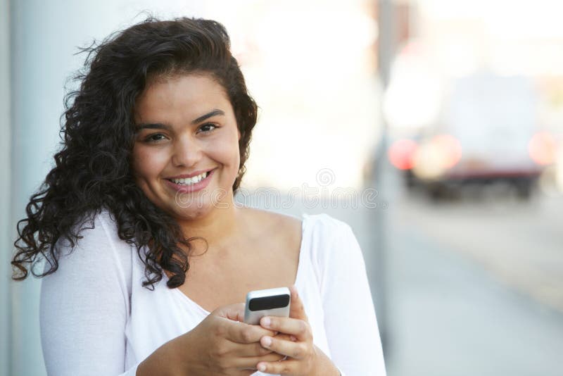 Young Woman Using Mobile Phone in Urban Setting Stock Image - Image of ...