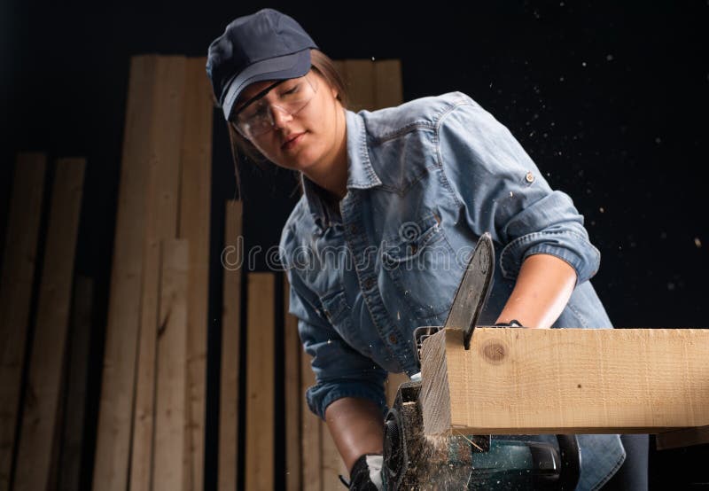 Young Woman Using Modern Electric Saw in the Workshop Stock Photo ...