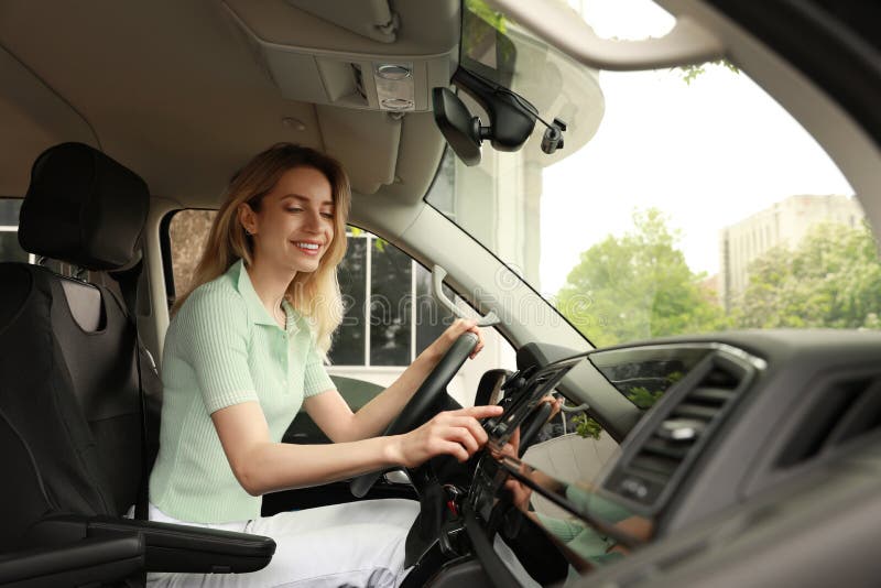 Young Woman Using Navigation System while Driving Car Stock Photo ...