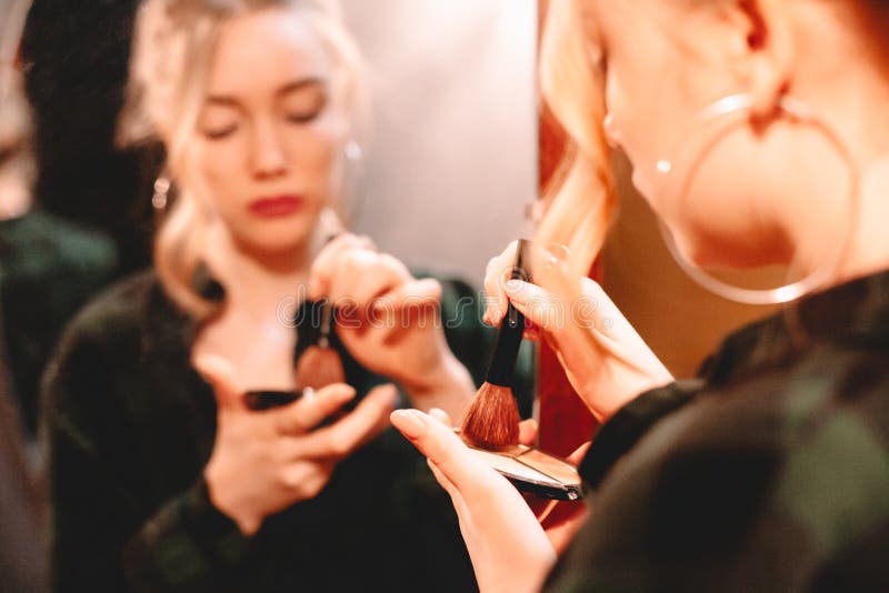 Young Woman Using Palette and Makeup Brush while Applying Make Up ...