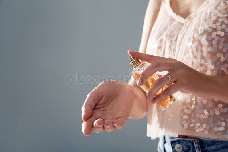 Young woman using perfume stock image. Image of female - 131007915
