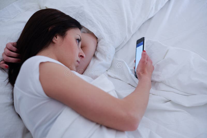 Young Woman Using Phone Lying in Bed Stock Image - Image of indoors ...