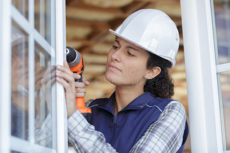 Young Woman Using Power Drill Installing Windows Stock Photo - Image of ...