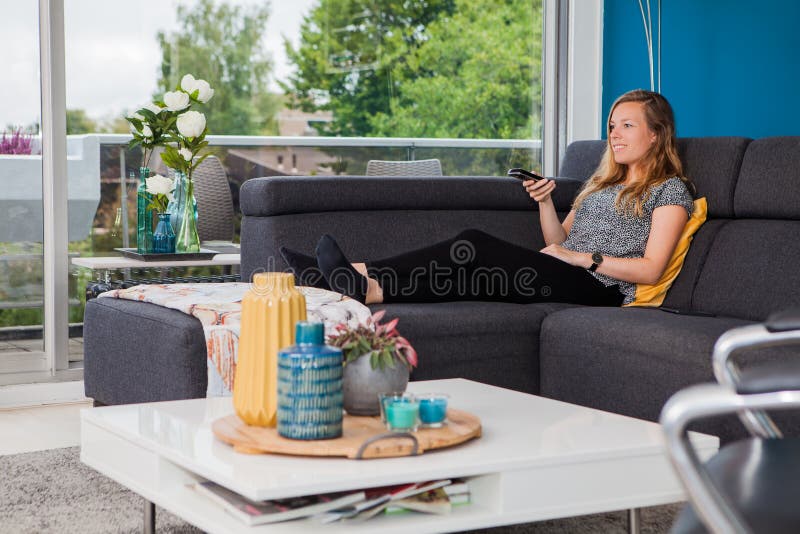 Young Woman Using a Remote Control on the Couch Stock Image - Image of ... Young Woman Using a Remote Control on the Couch Stock Image - Image of ...