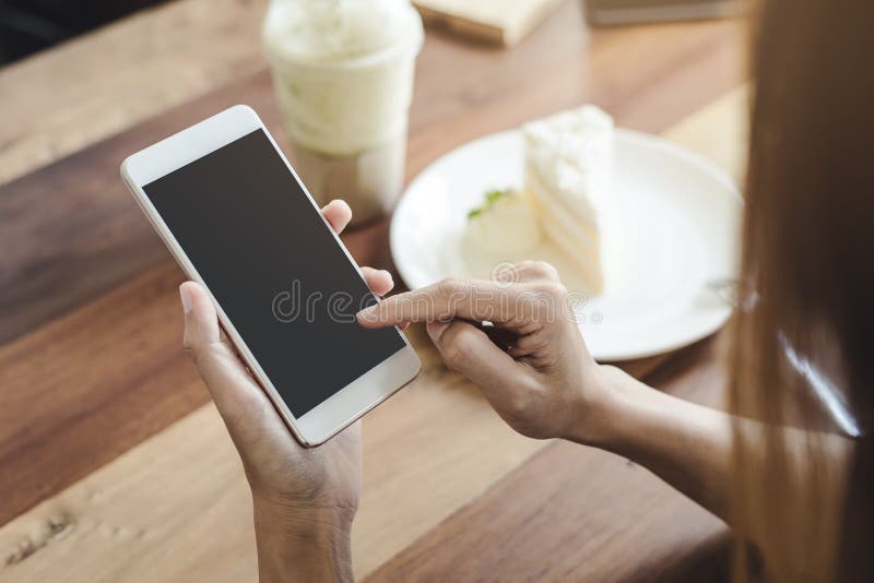 Young Woman Using Smart Phone and Eating Cake Stock Photo - Image of ...