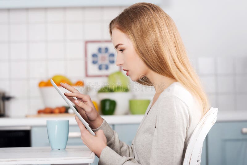 Young Woman Using a Tablet Computer at Home Stock Photo - Image of ...