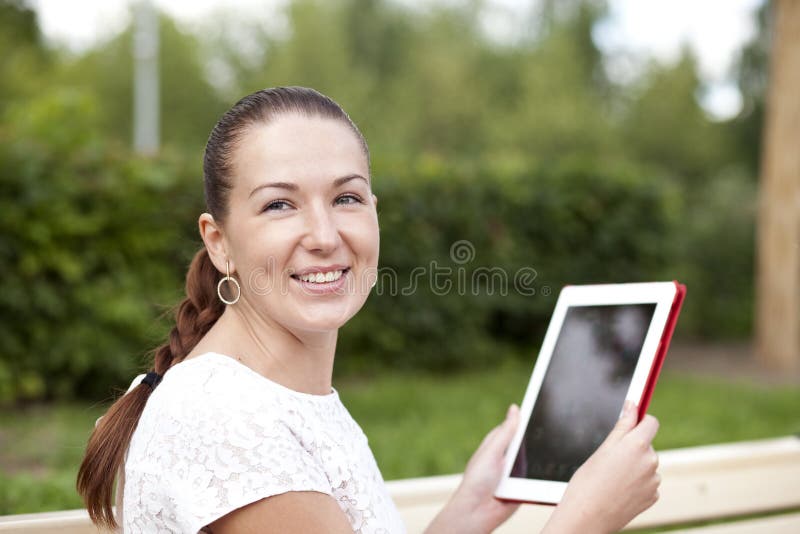 Young Woman Using a Tablet Computer on a Park Stock Photo - Image of ...