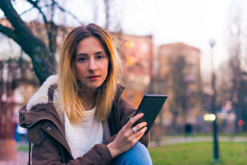 Young Woman Using Tablet Outdoor Smiling Stock Image - Image of nature ...