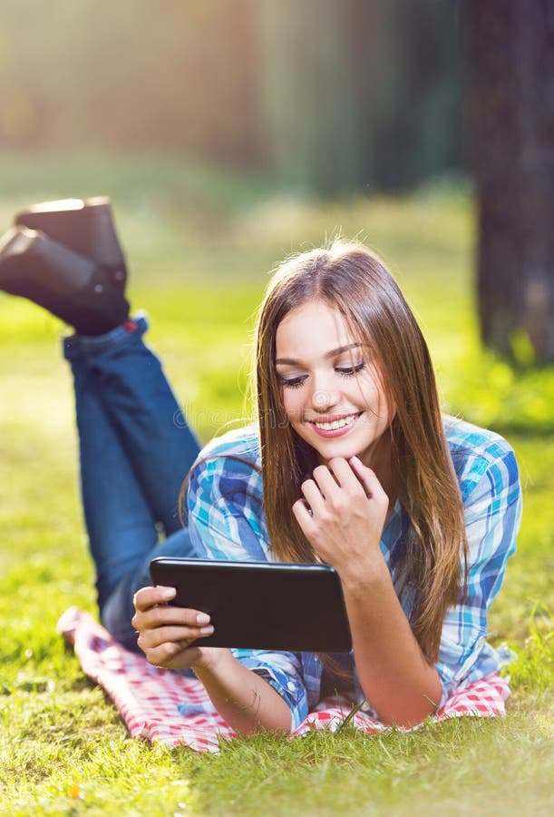 Young Woman Using a Tablet Outdoors Stock Photo - Image of outside ...