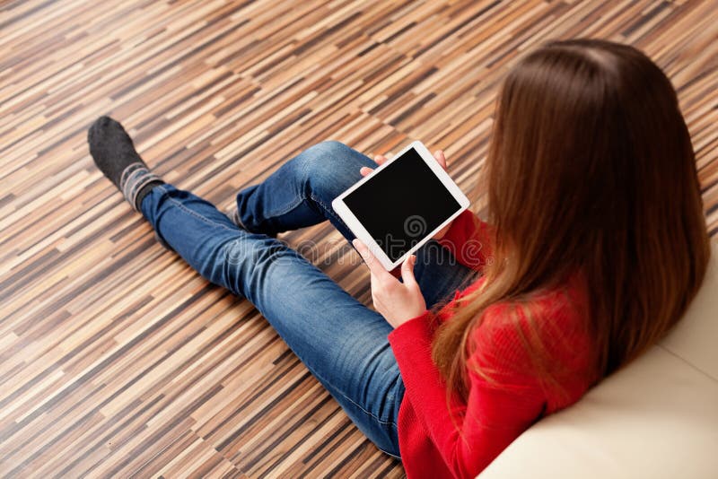 Young Woman Using Tablet Sitting on Floor Stock Photo - Image of ...