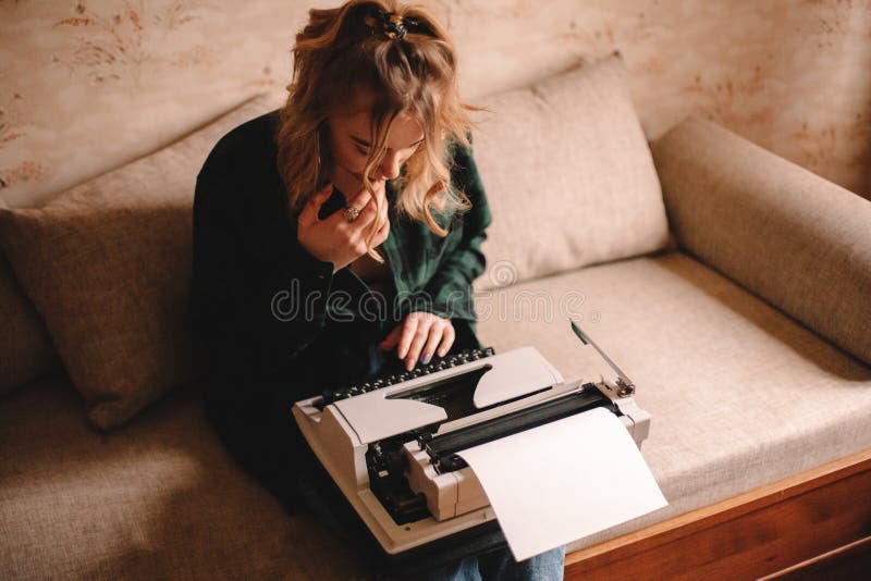 Young Woman Using Typewriter while Sitting on Sofa Stock Photo - Image ...