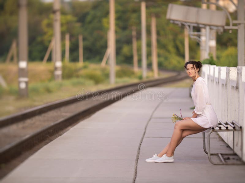 Young Woman Waiting for Someone Stock Photo - Image of flowers, luggage ...