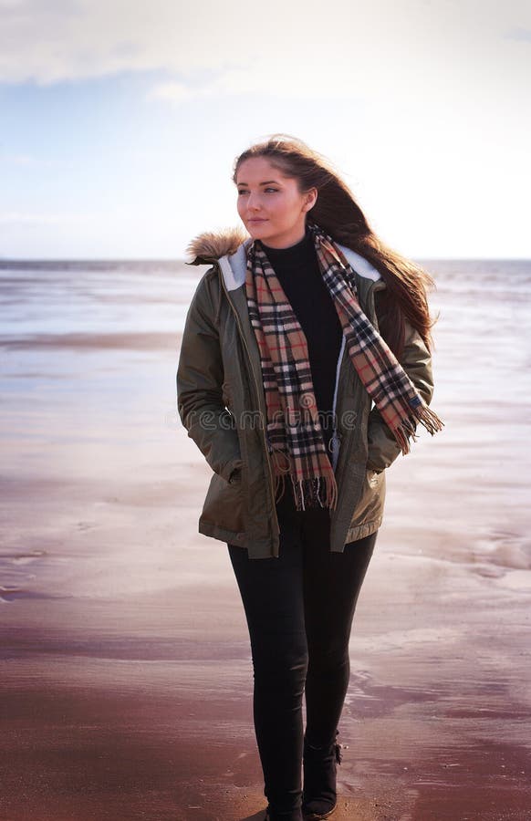 Young Woman Walking on a Beach on a Cold Day Stock Photo - Image of ...