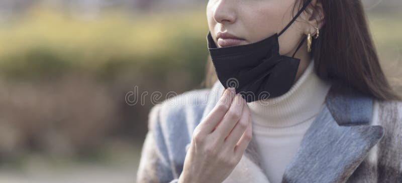 Young Woman Pulling Her Face Mask Down Outdoors Stock Image - Image of ...
