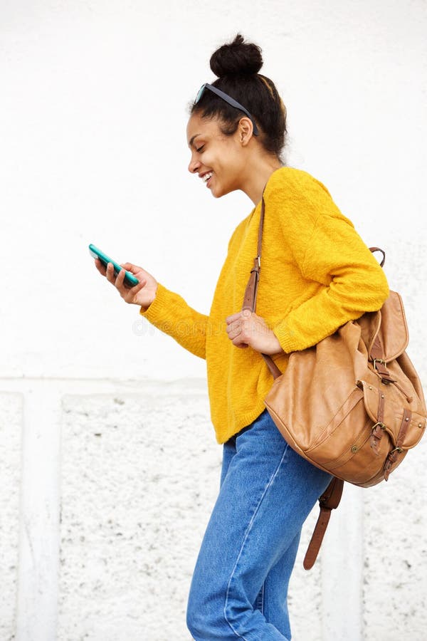 Young Woman Walking Outdoors and Using Mobile Phone Stock Image - Image ...